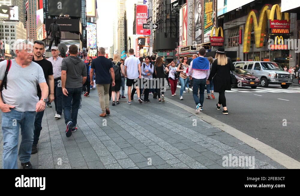 People Crossing A Very Busy Intersection In Times Square New York Stock ...