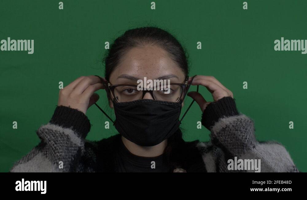 Young Woman Putting On Face Mask. Green Screen, Locked Off Stock Video ...