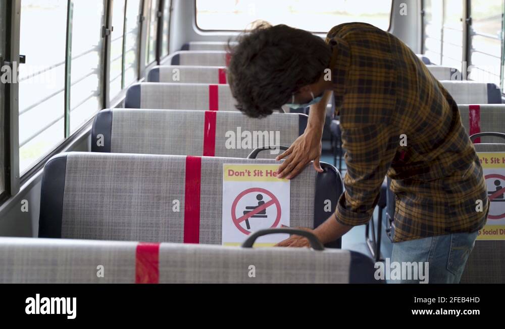 Man pasting don't sit here notice board on bus seat Stock Video Footage ...