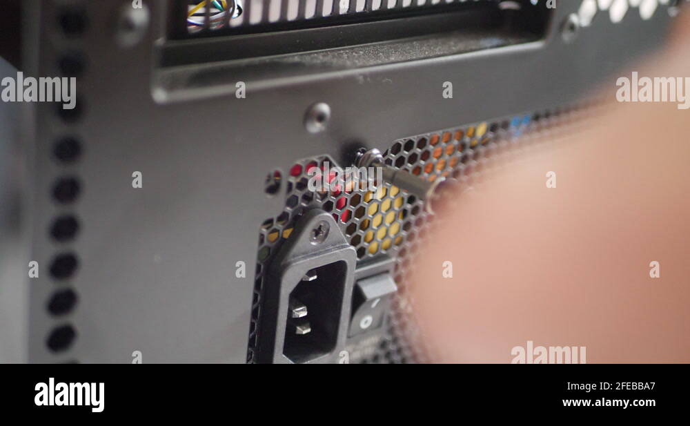 A computer repair technician assembling a new gaming pc case with a ...