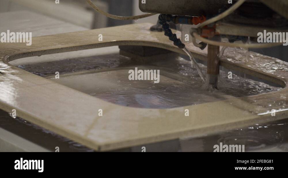 Water cooled stone router milling a sink hole in a new granite ...