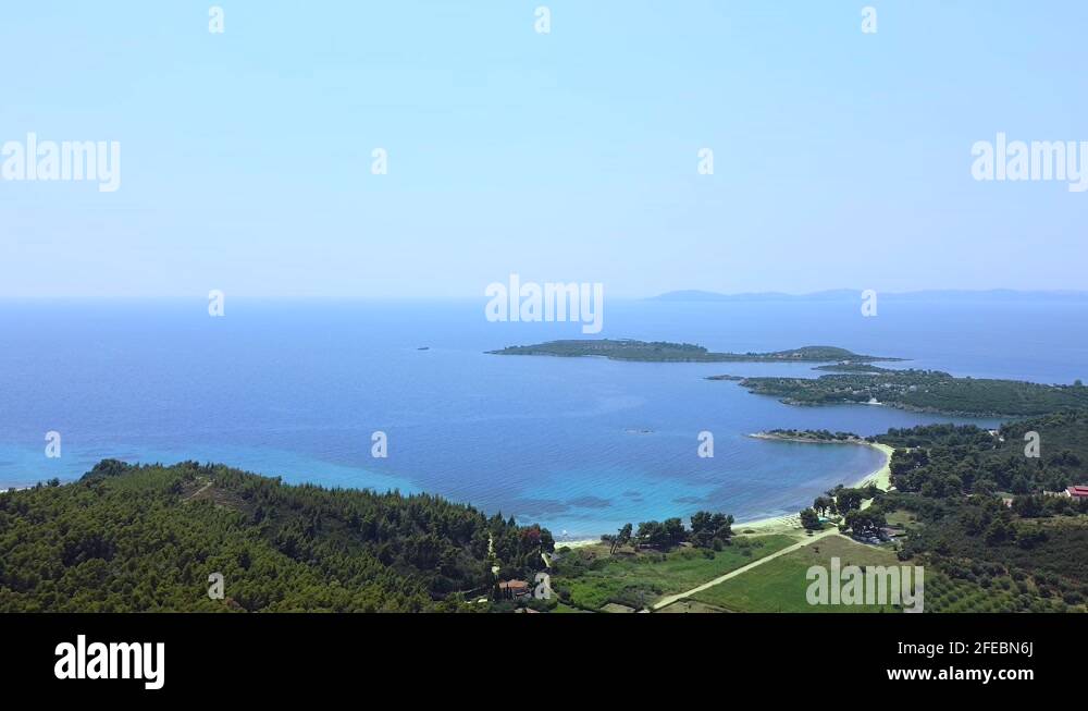 Seacoast with trees, vacation resort and sand beaches on blue sea ...