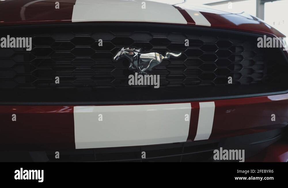 Chrome Ford Mustang Grille Logo Emblem on Red Car with Racing Stripes ...