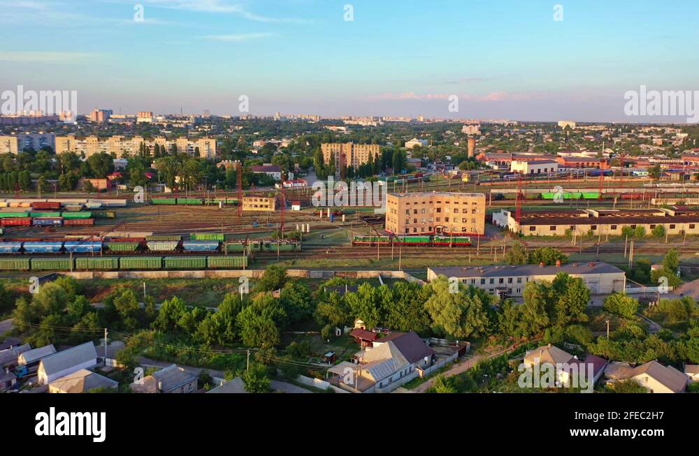 A bird's-eye view of a large railway station with lots of carriages ...