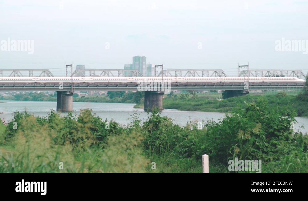 Wide Angle Shot Of A Shinkansen Bullet Train Moving On The Iron Bridge ...