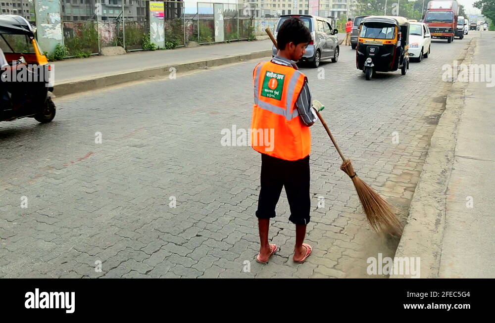 A Sweeper Sweeping the road early morning in Mumbai Stock Video Footage ...