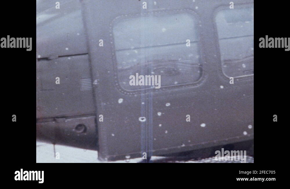 1960s Vietnam: Helicopter riddled with bullet holes. Wounded men lay on ...