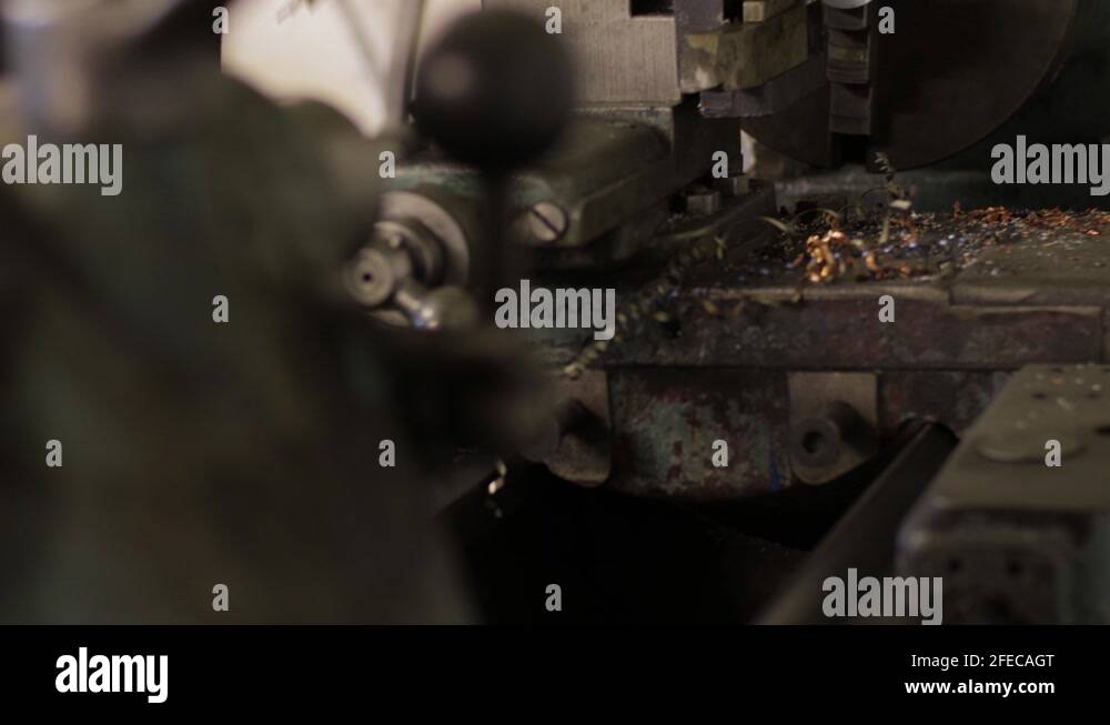 Machine shop on the countryside using a lathe and measuring the ...