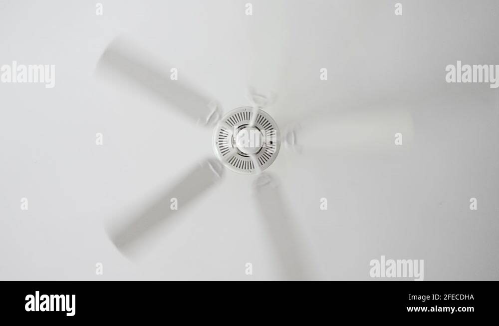 White ceiling fan on white ceiling background Stock Video Footage - Alamy