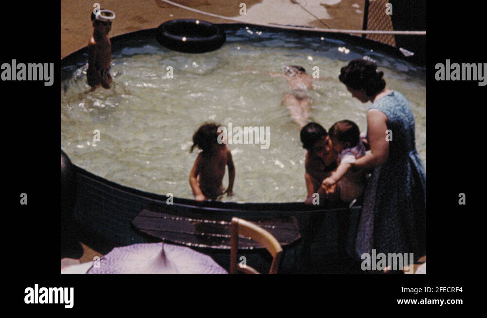 1960s: Children swim, play in pool in yard Stock Video Footage - Alamy