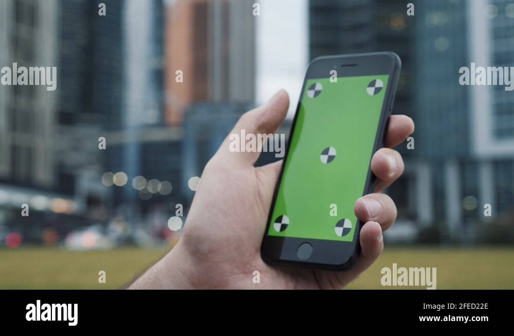 Scrolling a phone with green screen chroma key, background of business ...