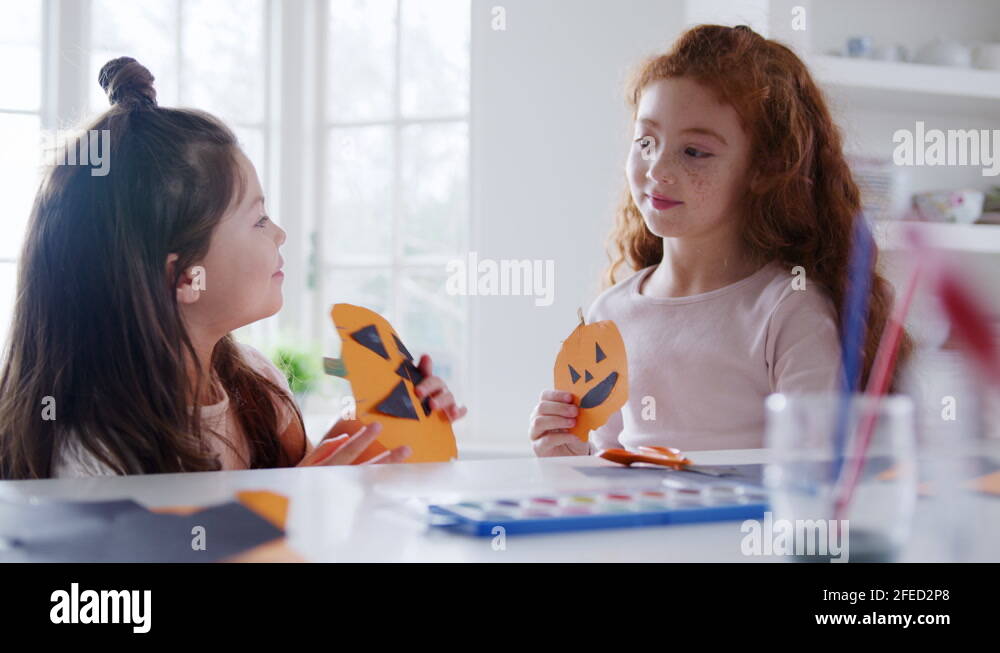 Two Girls At Home Having Fun Making Craft Halloween Decorations ...