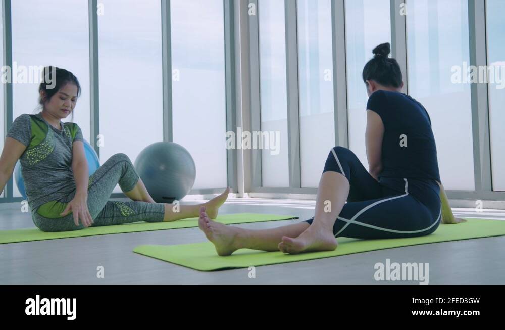 Exercise concept. Female athletes stretching in the gym. 4k Resolution ...
