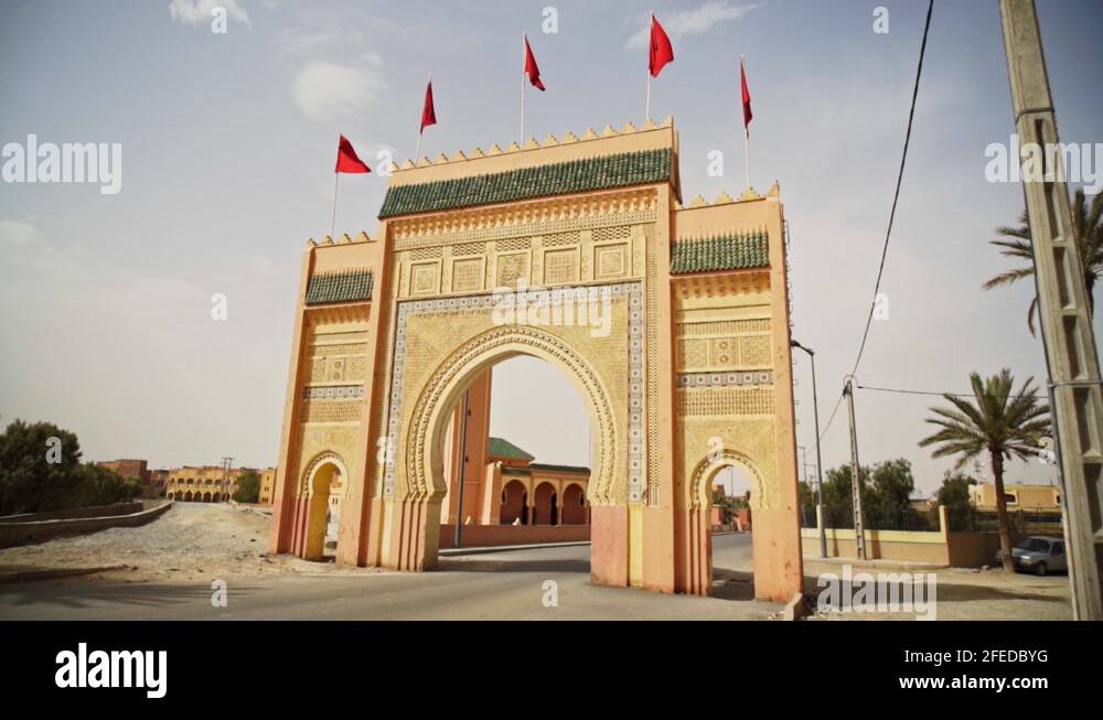 Traditional Moroccan gate with red flags on top, Gate to the Sahara ...
