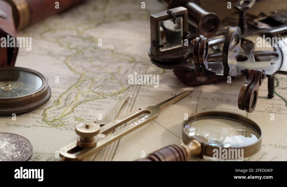 Dolly shot of sextant and other instruments on ancient world map of the ...