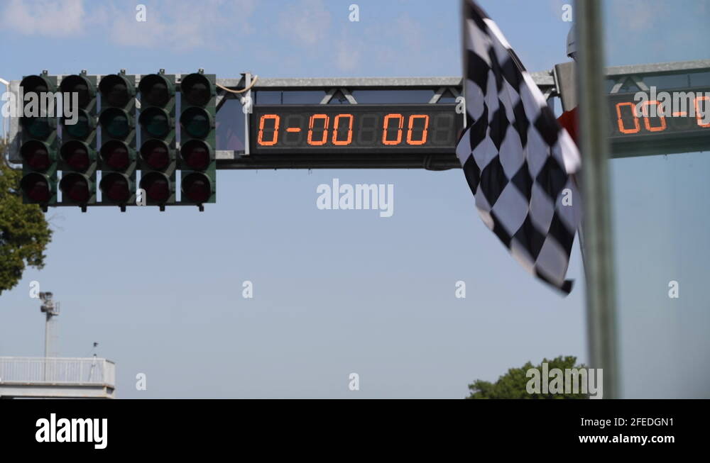 Waving checkered flag on motorsport circuit finish line real time Stock ...