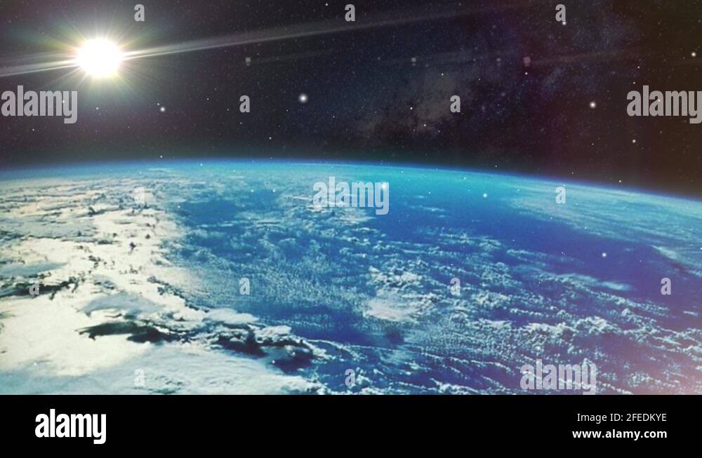 the surface of the planet earth a bright light above the atmosphere ...