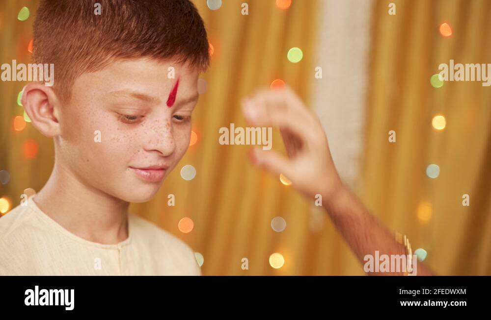applying bindi during festival to boy Stock Video Footage - Alamy