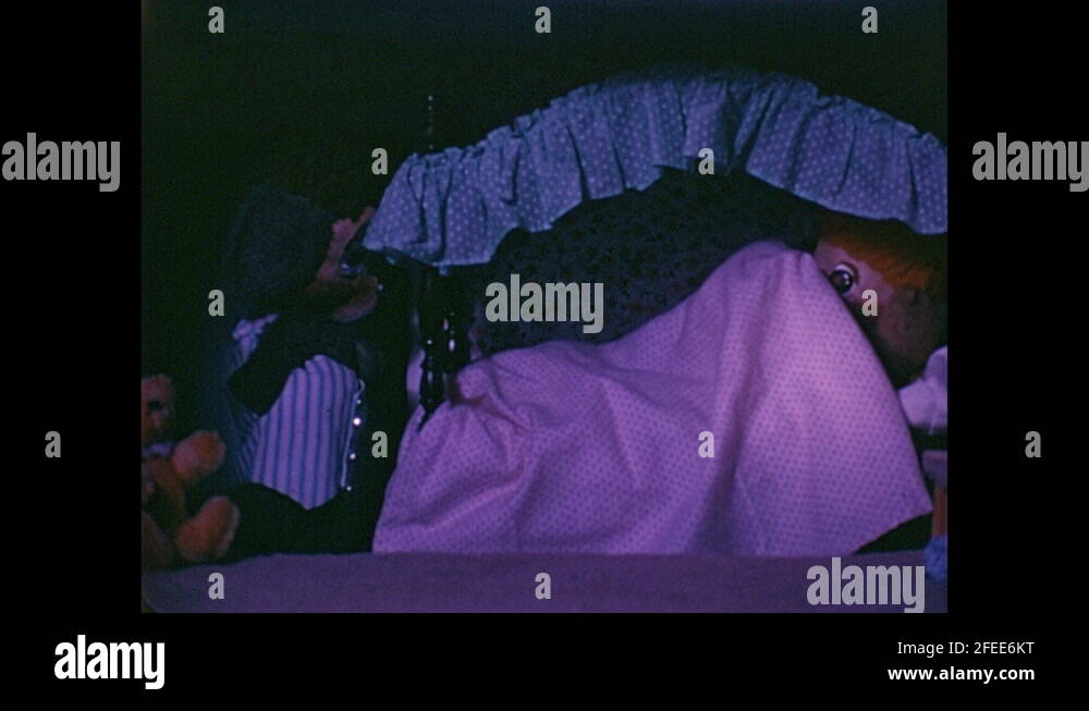 1970s: Girl mouse puppet hides under covers in bed. Father mouse puppet ...