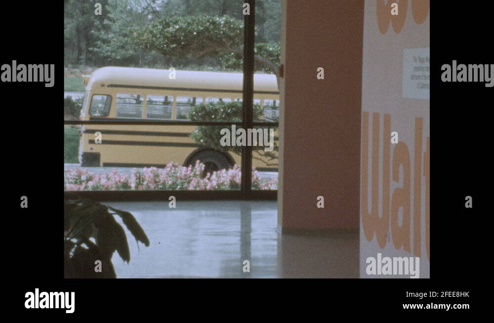 1970s: Hallway, view of school bus through window, Hands hit clapboard ...