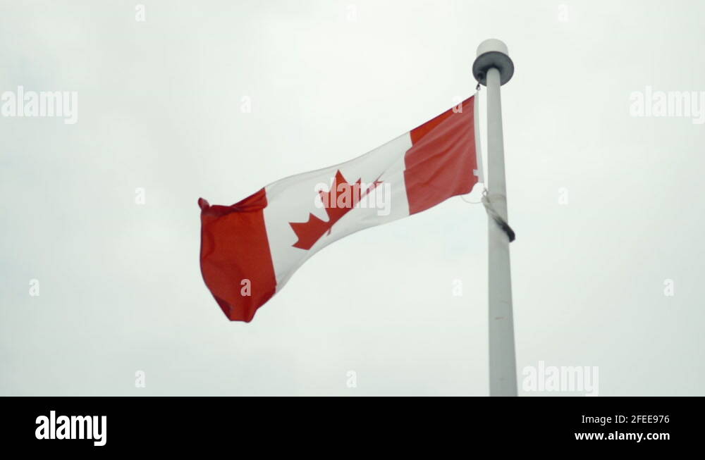 Canadian flag blowing in wind in slow motion Stock Video Footage - Alamy