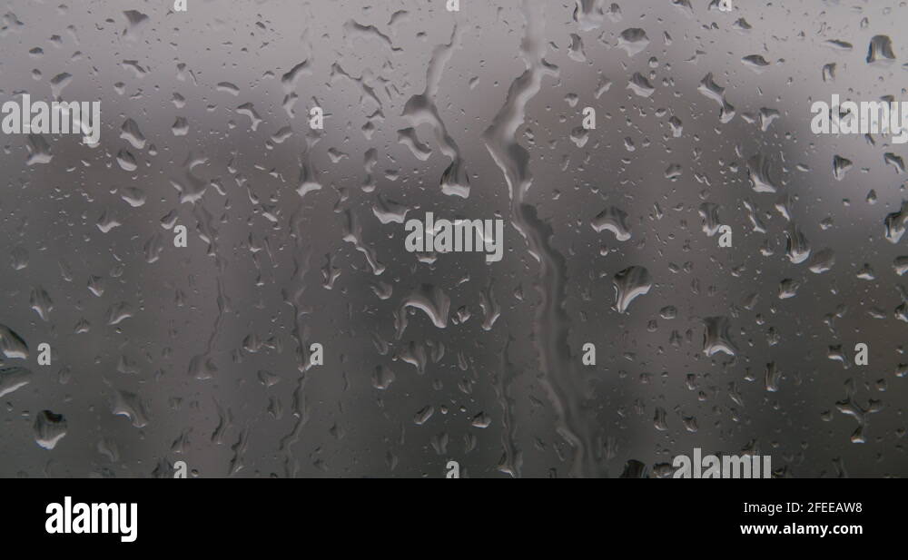 real rain drops sliding on window glass Stock Video Footage - Alamy