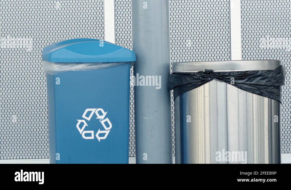 Garbage can and recycling bin side by side in building hallway Stock ...