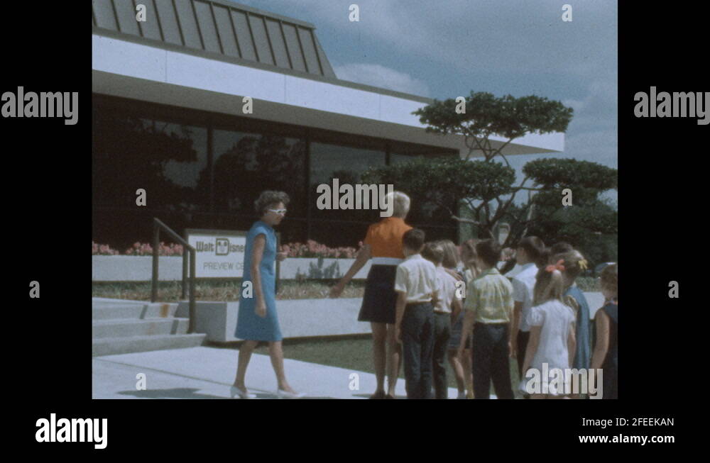 1970s: Shots of building exterior, woman walks down steps, greets woman ...