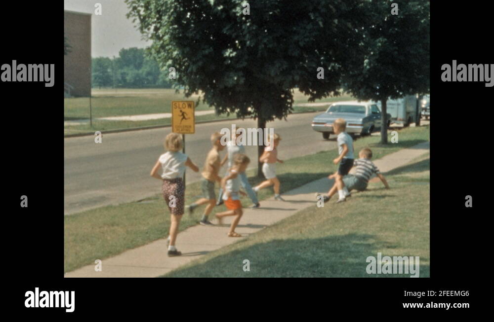 1960s: Shots of kids playing on sidewalk, car drives past Stock Video ...