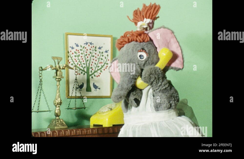 1970s: Girl mouse puppet talks to girl elephant puppet on telephone ...