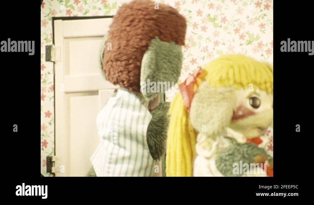 1970s: Father and girl mouse puppets look in bedroom closet. Father ...