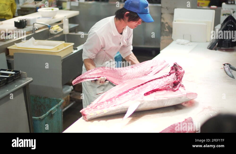 Fish Butcher Dissecting Big Fish Tuna In Front Of The Audience At ...