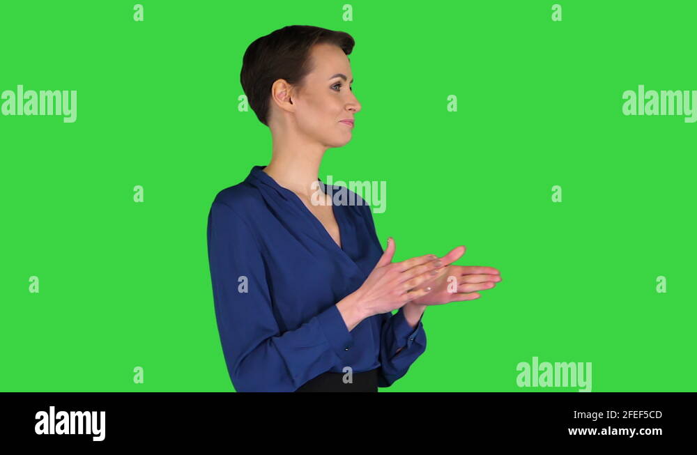 Attractive caucasian business woman clapping her hands on a Green ...