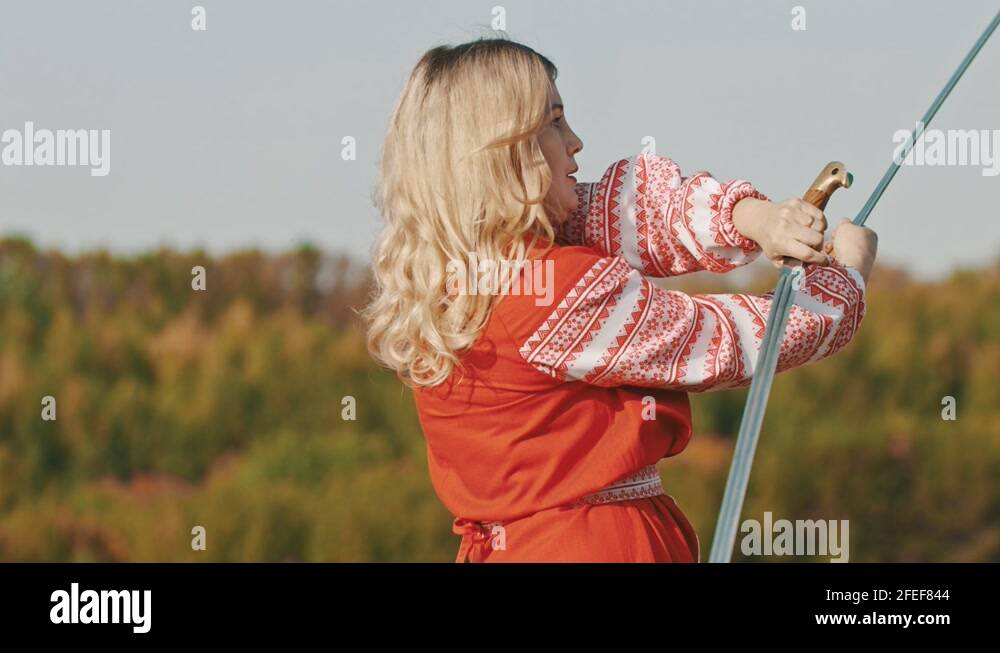 Feisty adult woman in red national dress fighting with two swords Stock ...