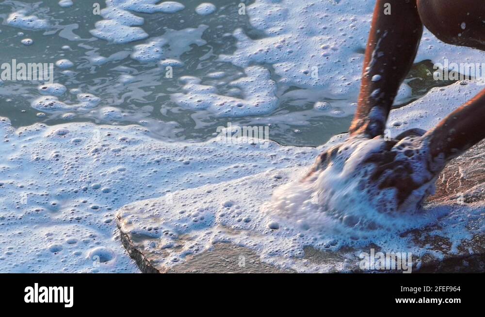 Hands Washing Clothes On The Flat Rock In Varanasi,India With Soap ...