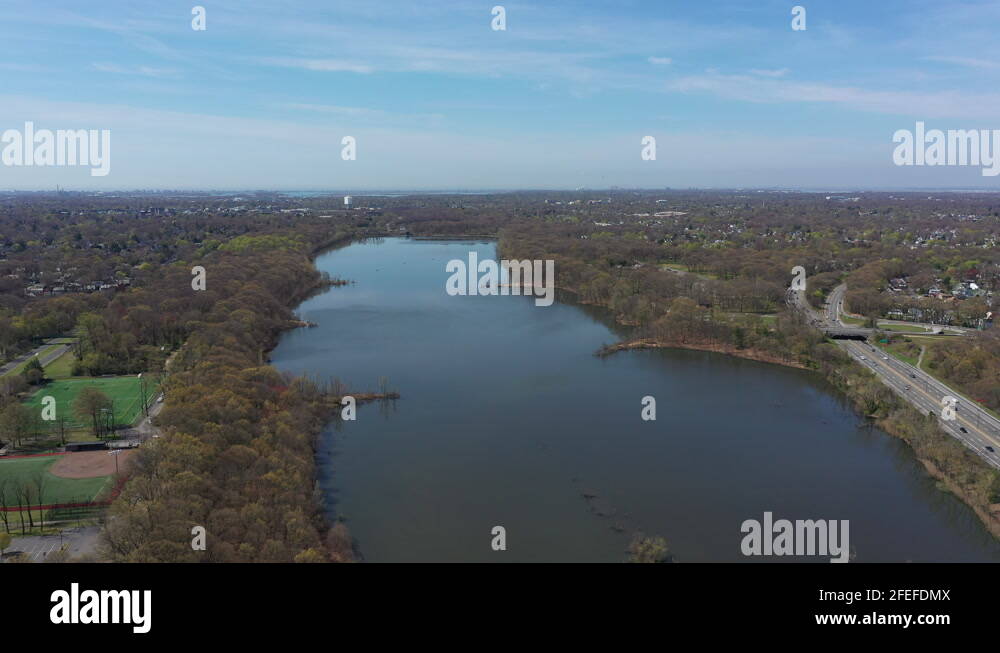 An aerial view of a reflective lake during the day. The horizon is ...