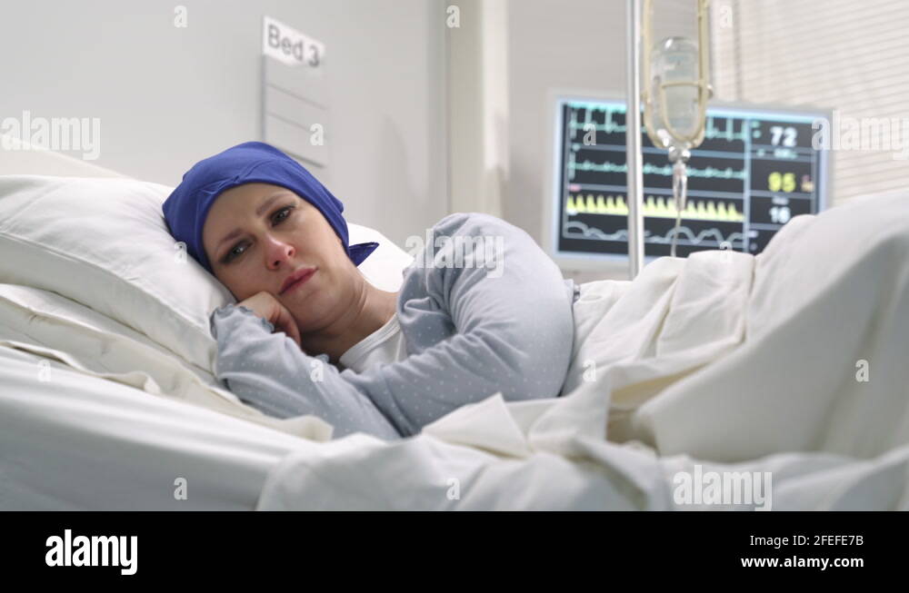 sad desperate terminal cancer ill female patient in the hospital bed ...