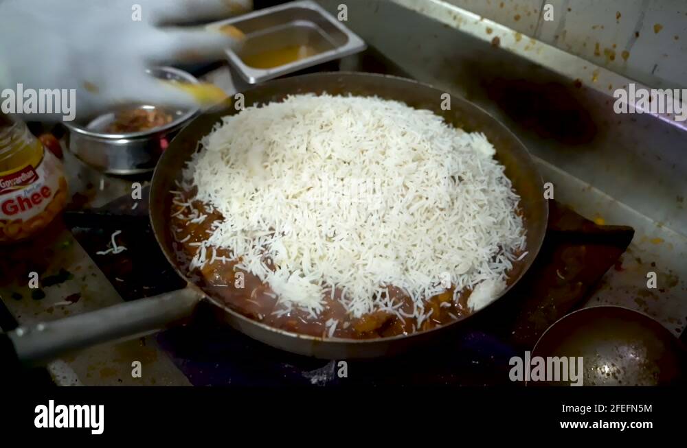 Long Grain Half-Cooked Basmati Rice Placed On Top Of A Chicken Biryani ...