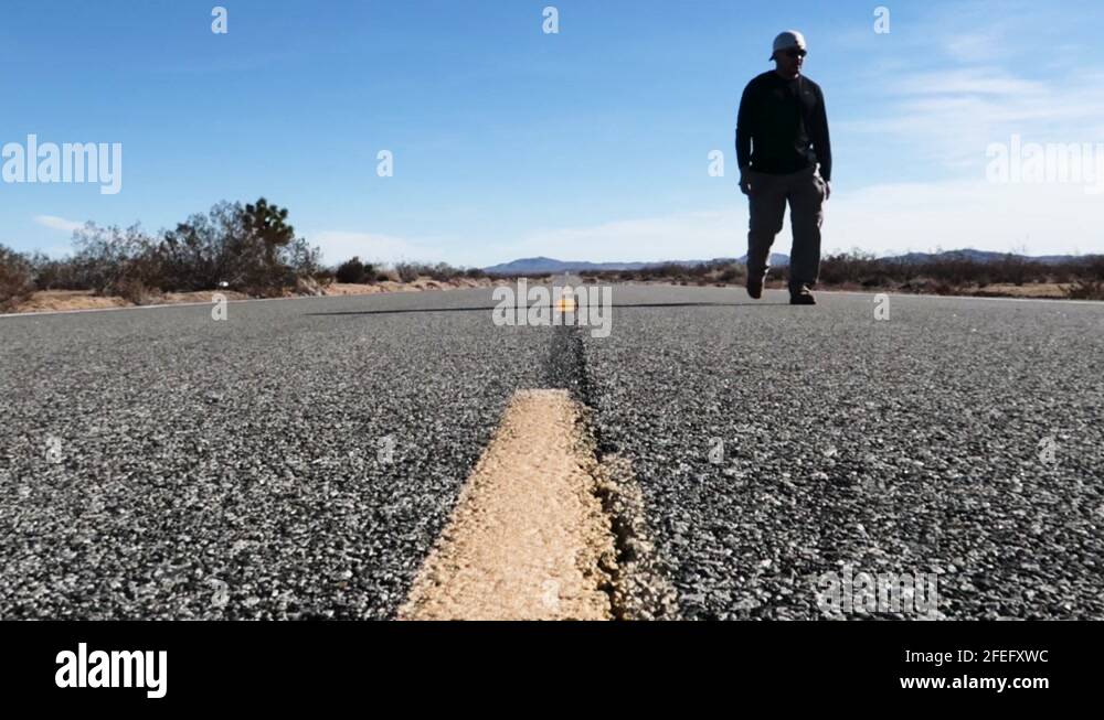 Man walking in the middle of the road Stock Videos & Footage - HD and ...