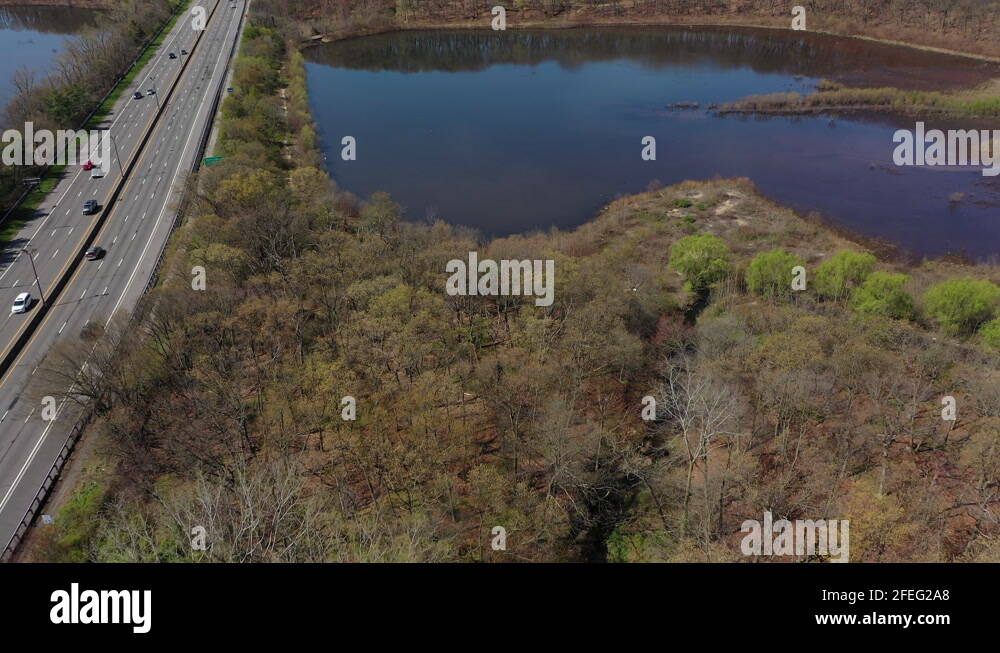 An aerial view of a reflective lake during the day. The drone camera ...