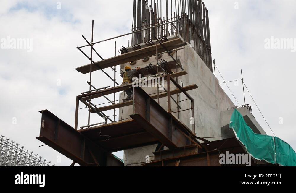 Construction workers installing the pre-stress cable and tendons at the ...