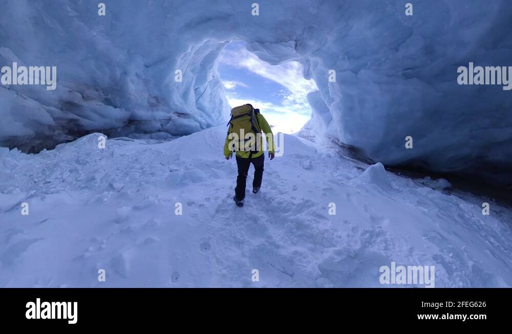 Man walks through a glacier cave in slow motion. Italian Alps - South ...