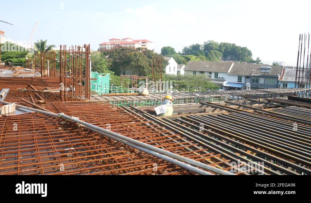 Construction workers fabricating steel reinforcement bar & timber ...