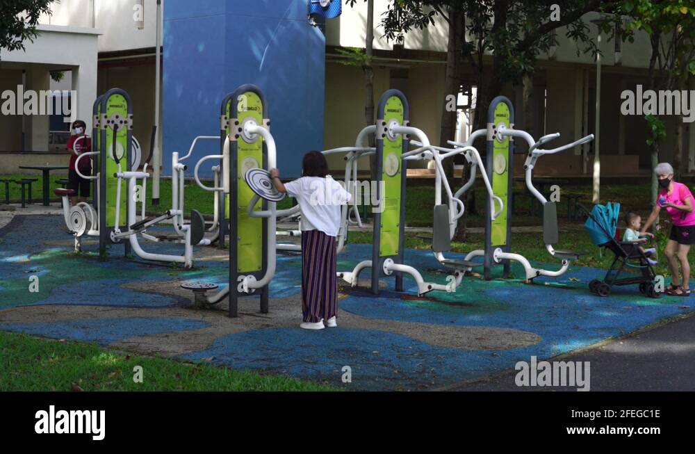 Multi generation group at a fitness corner, open air exercise at HDB ...