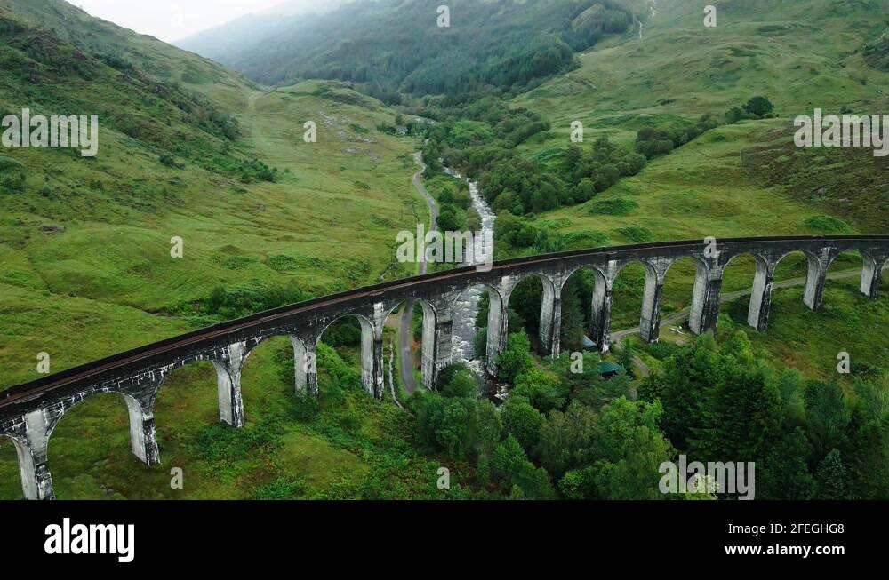 Famous Glenfinnan Viaduct Crosses River Finnan And Lush Mountain Hills ...