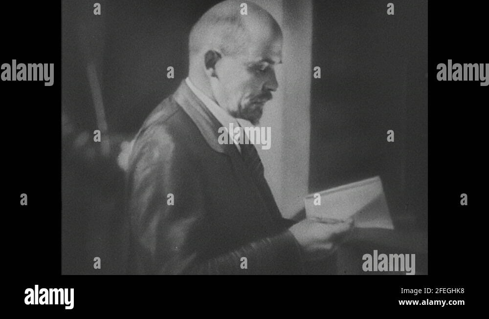 1910s Russia: Office with bookshelves and desks. Lenin in profile ...