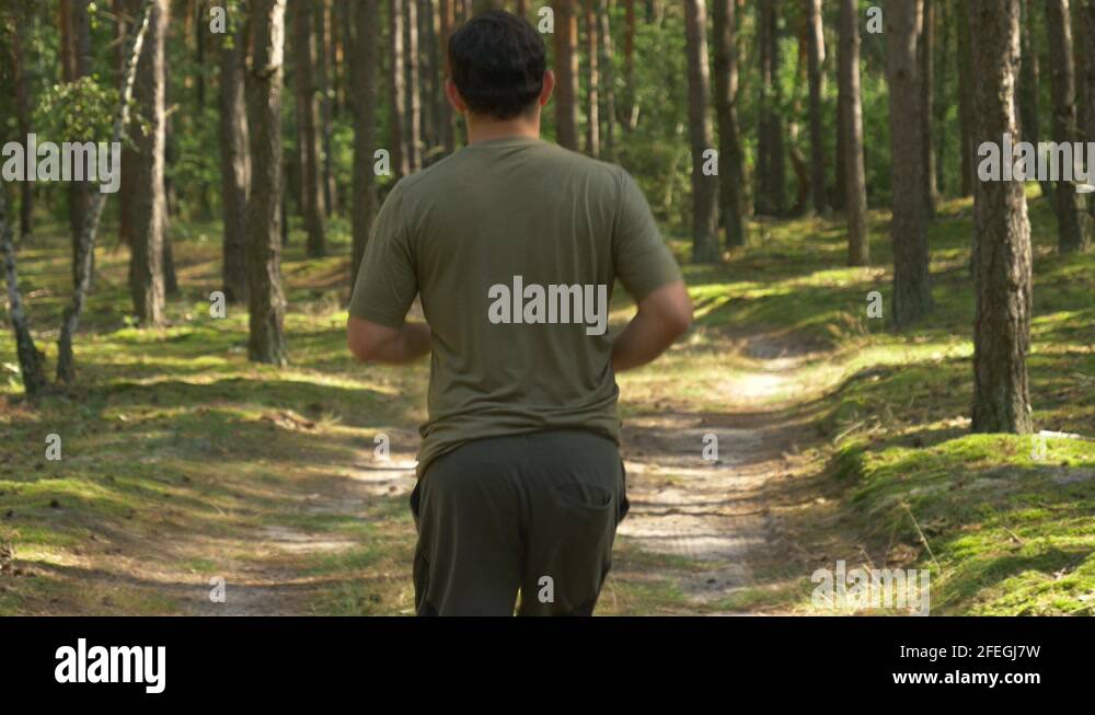Back View Of An Active Man Enjoying A Mile Of Running At The Pathway Of ...