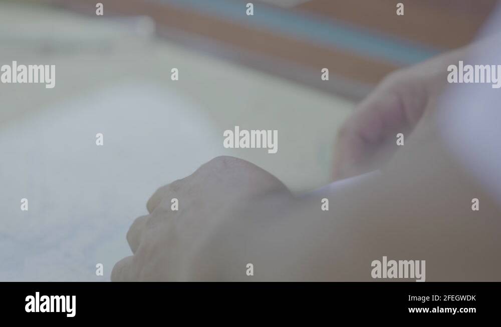 Two hands are folding paper into a boat-like figure and shape Stock ...