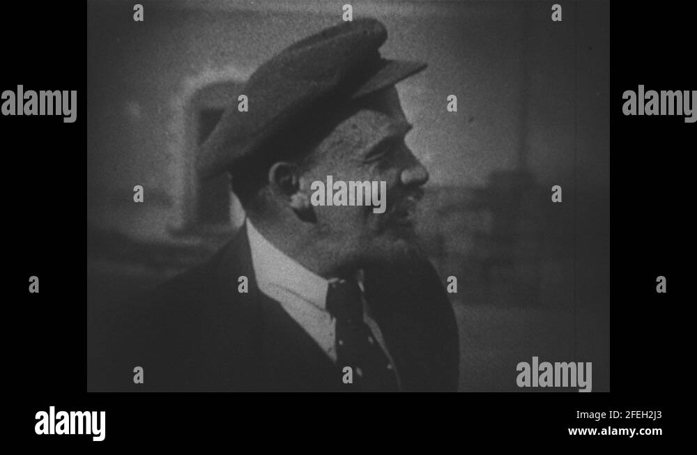 1910s USSR: Statue of Lenin pointing. Footage of Lenin speaking in cap ...