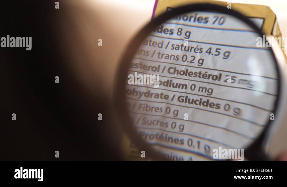 Looking at a Nutrition Information Label with a Magnifying Glass Stock ...